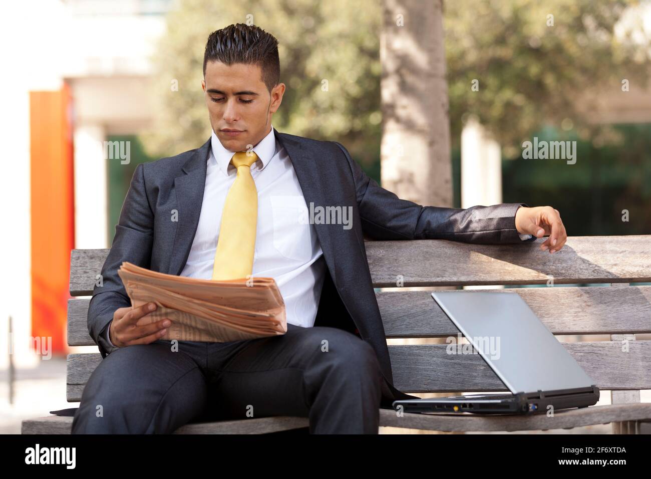 Businessman reading his newspaper next to his office building Stock ...