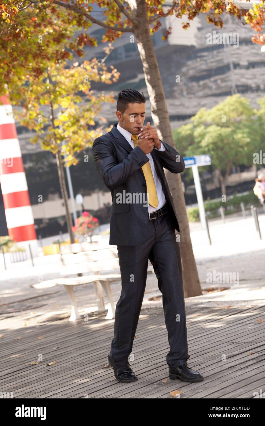 Businessman smoking a cigar to relax Stock Photo - Alamy