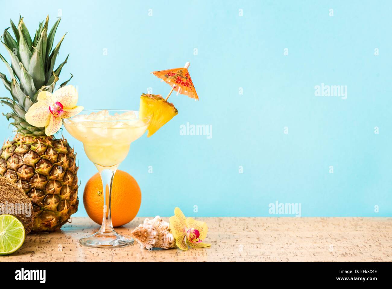 Summer tropical cocktail drink, fruits and flowers, blue sea background ...