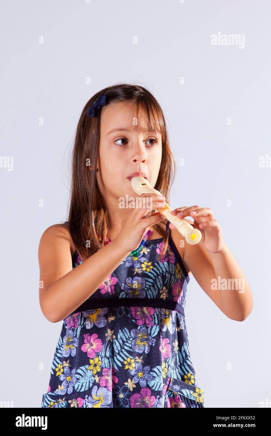Little girl playing music with a flute Stock Photo - Alamy