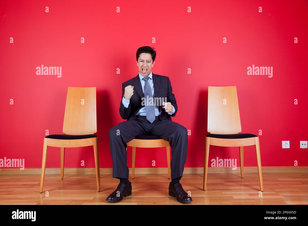 One successful businessman between two empty chairs Stock Photo - Alamy