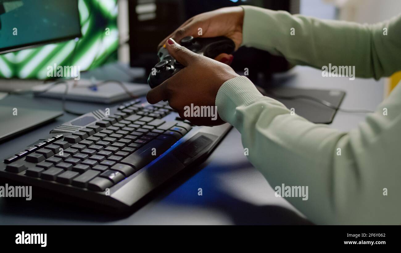 Close-up of professional cyber gamer holding joystick playing space ...
