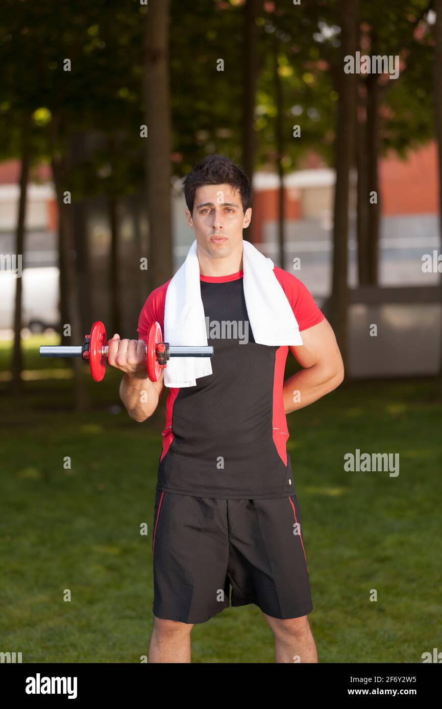 Strong man lifting weights at the park Stock Photo - Alamy