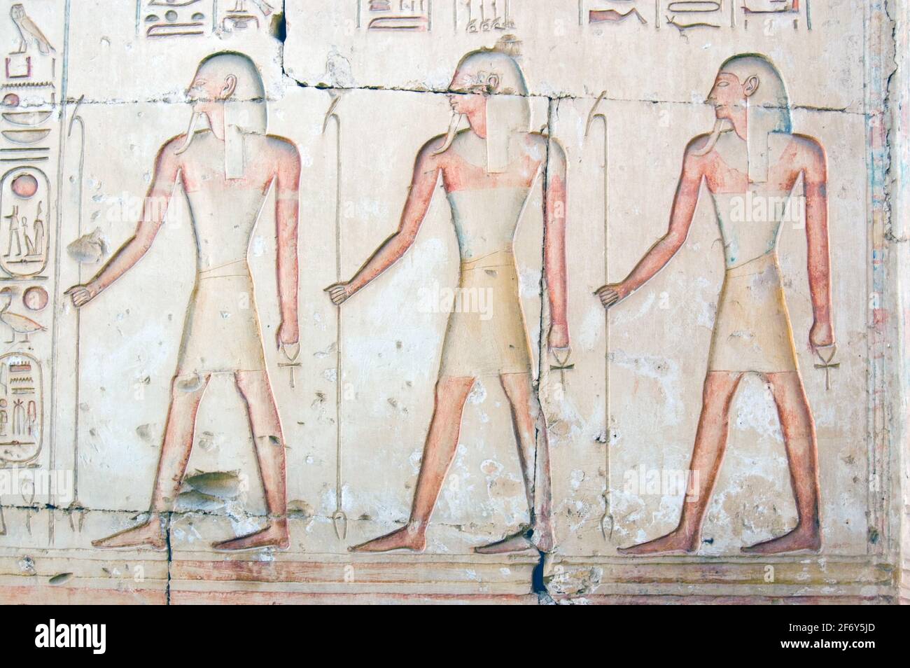 A trio of ancient egyptian priests carved and painted on the side of a ...