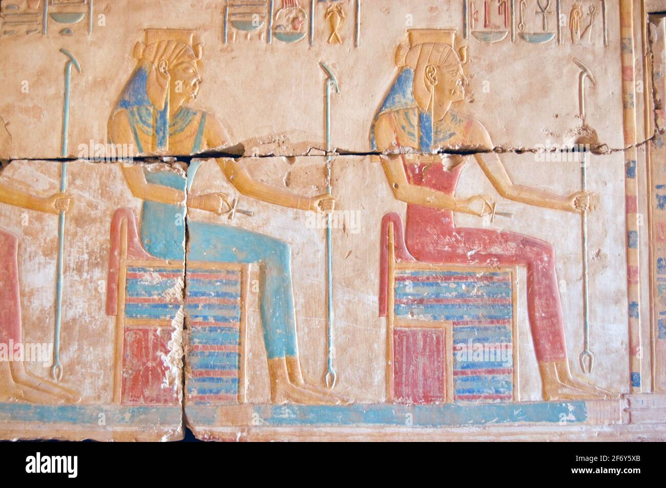 Bas relief carving of the goddess Isis sitting holding an ankh and ...