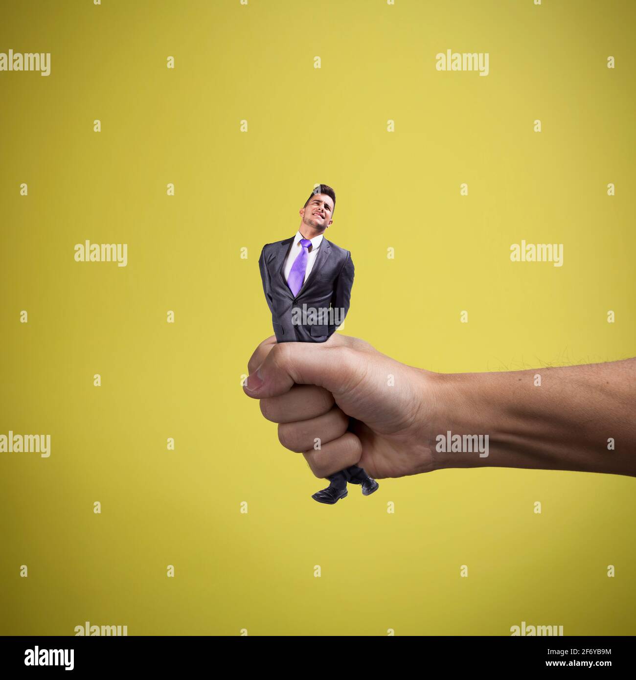 Hand squeezing a young businessman Stock Photo - Alamy