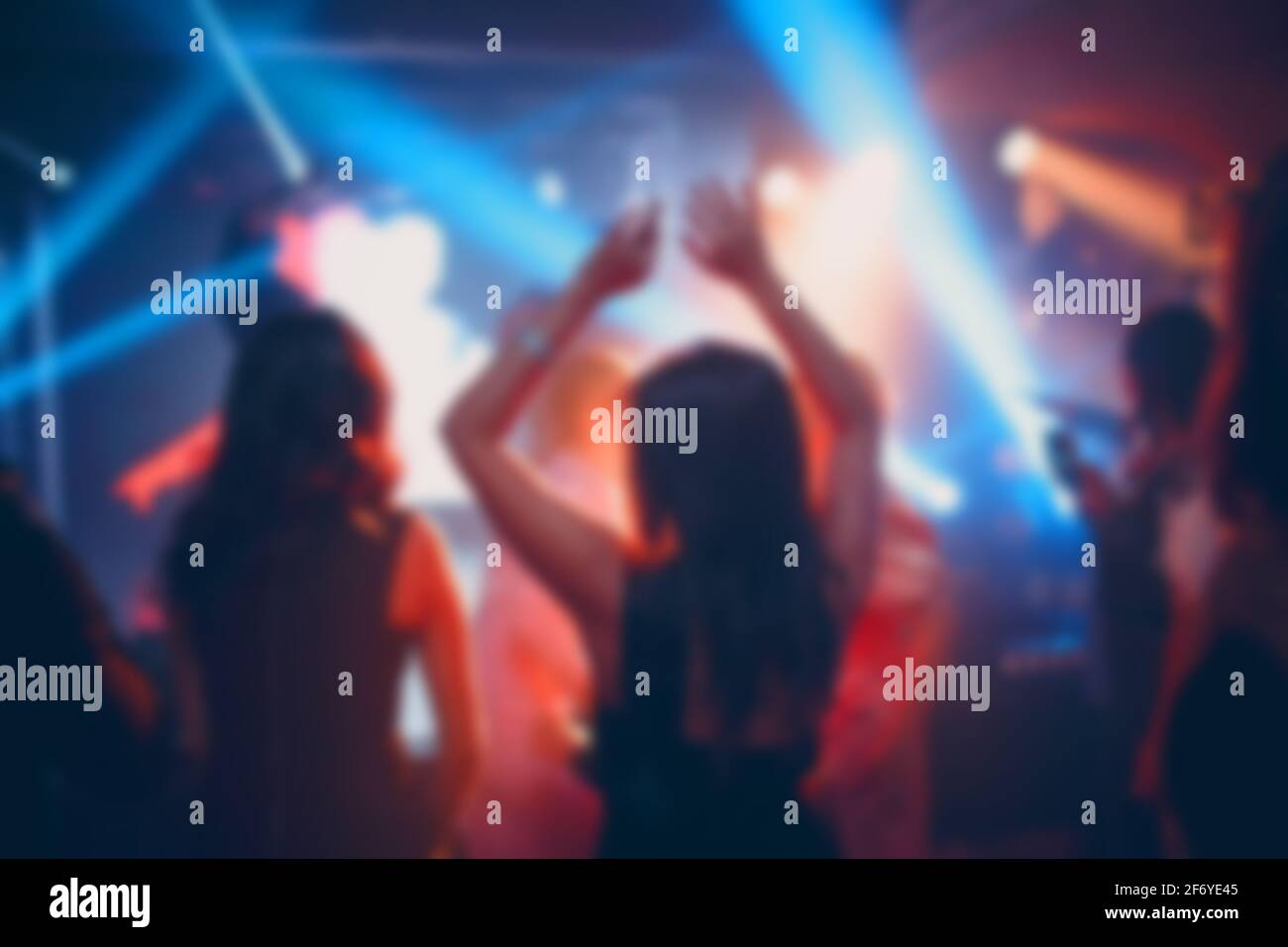 Silhouettes of a crowd on show in night club celebration. Blurred ...