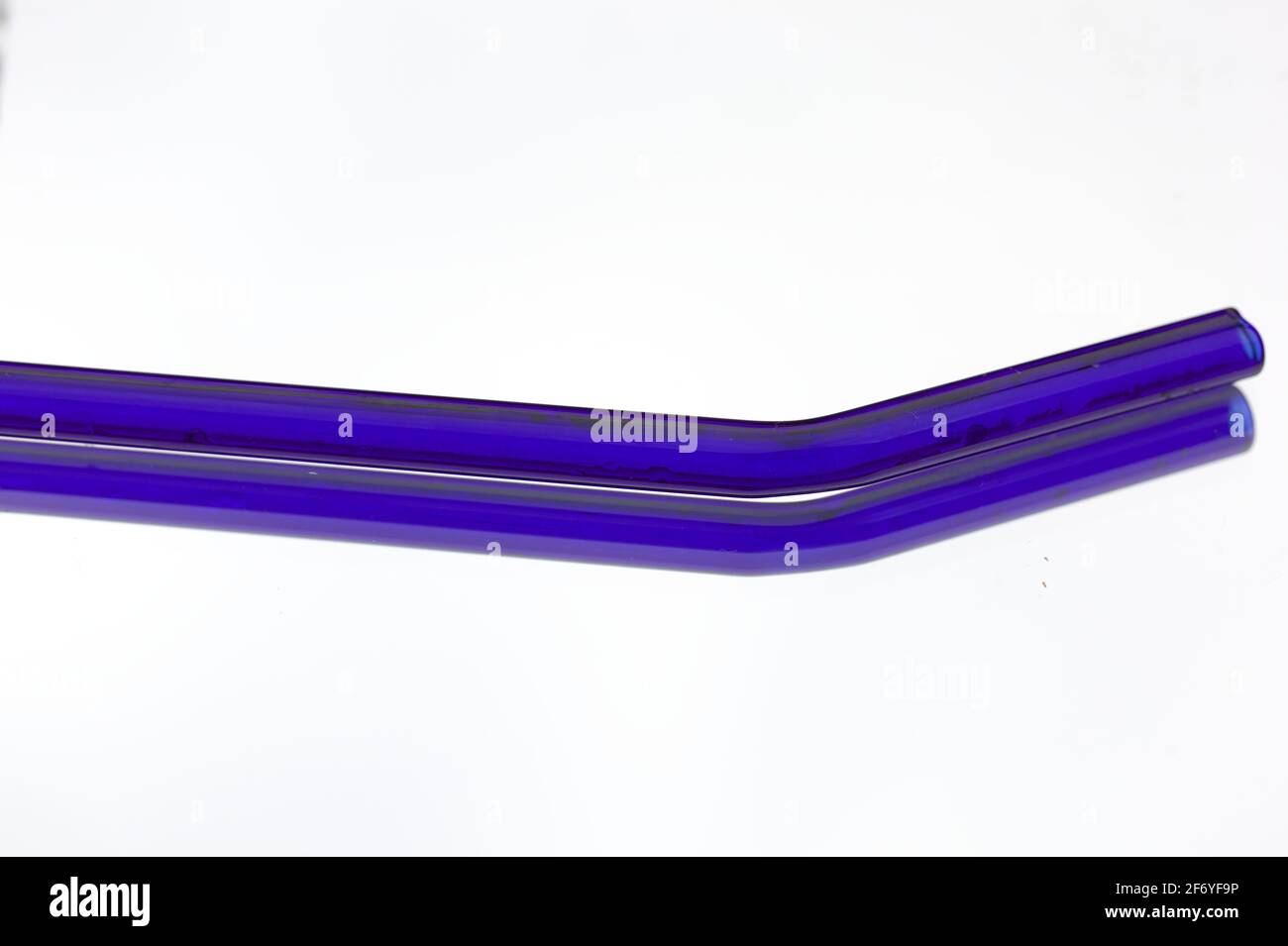 Close-up abstract of blue glass and reflection on a mirrored background ...