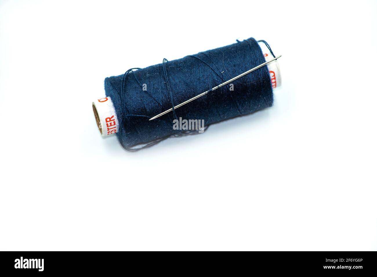 Mumbai , India - 15 March 2021, Navy blue sewing wire and needle with a ...