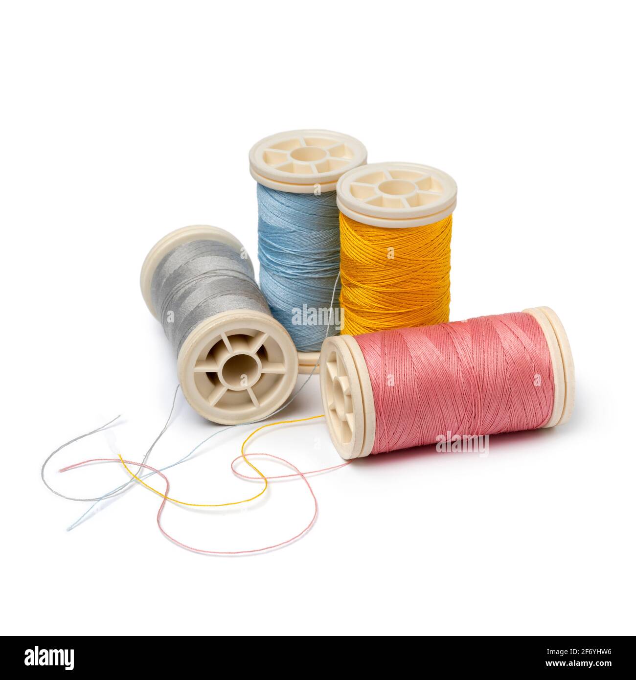 Colorful spools of yarn isolated on white background Stock Photo - Alamy