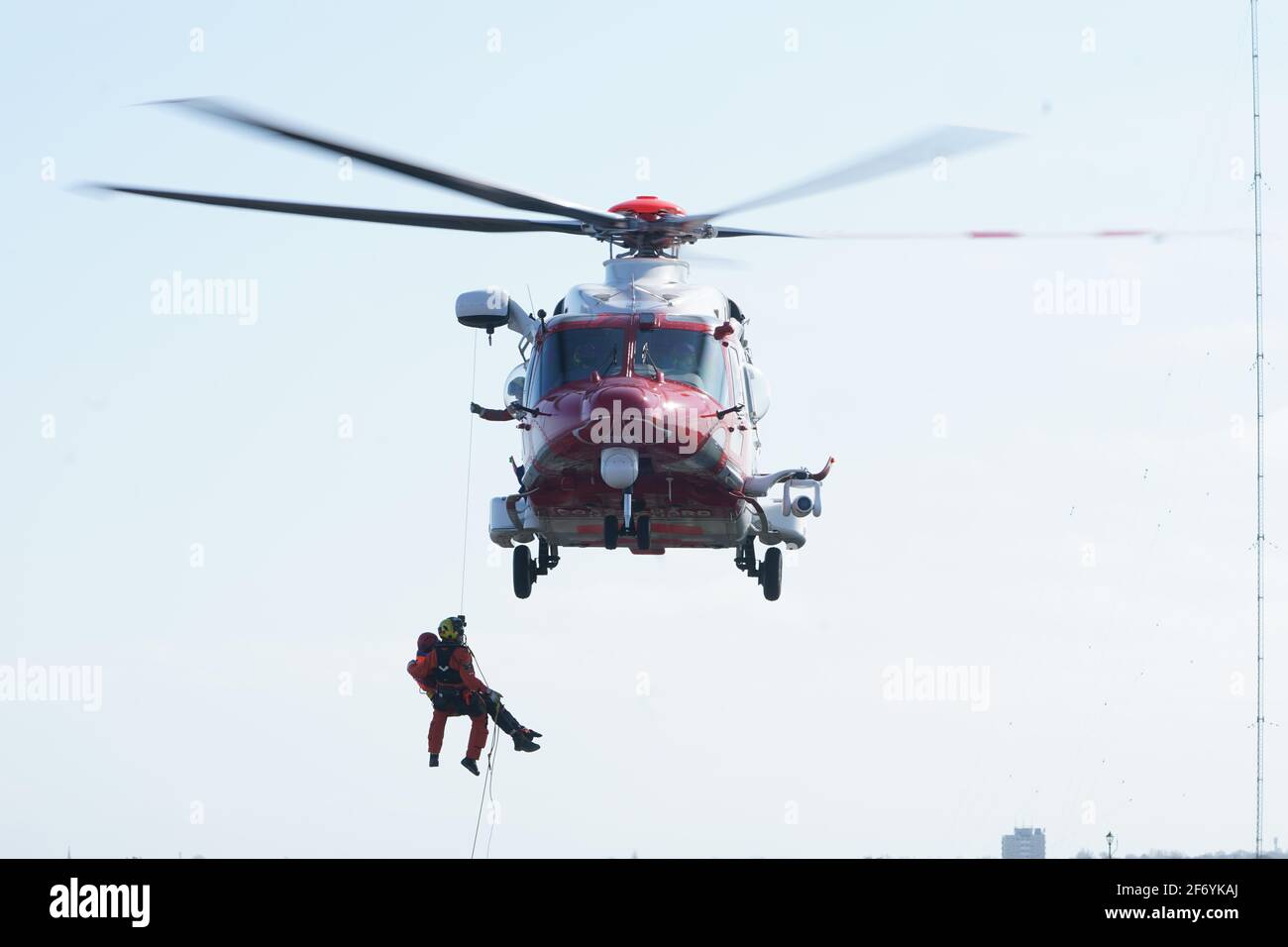 An HMS coastguard helicopter airlifts a person to safety at Old Hartley ...