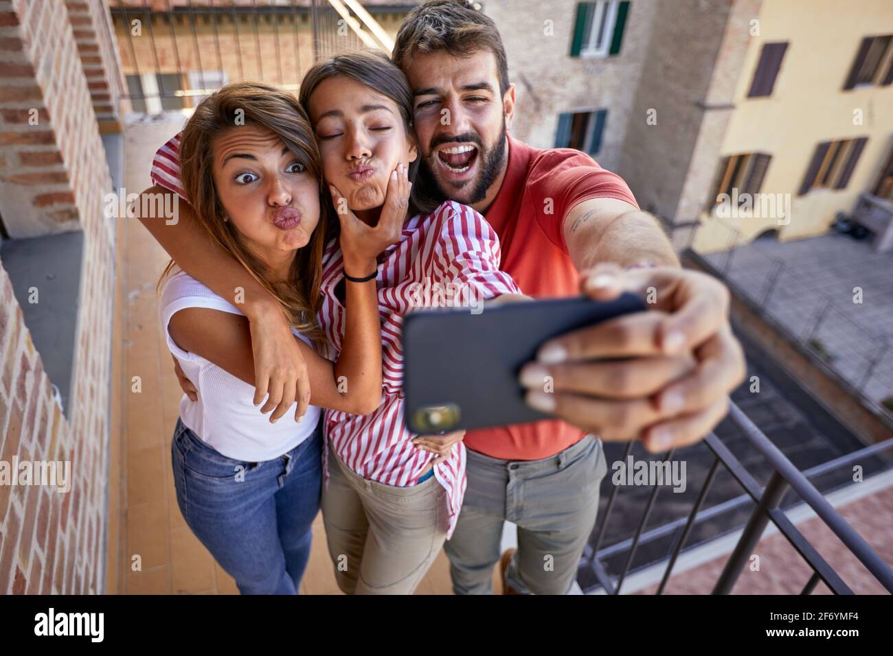 Group of cheerful friends having fun while taking selfies on the ...