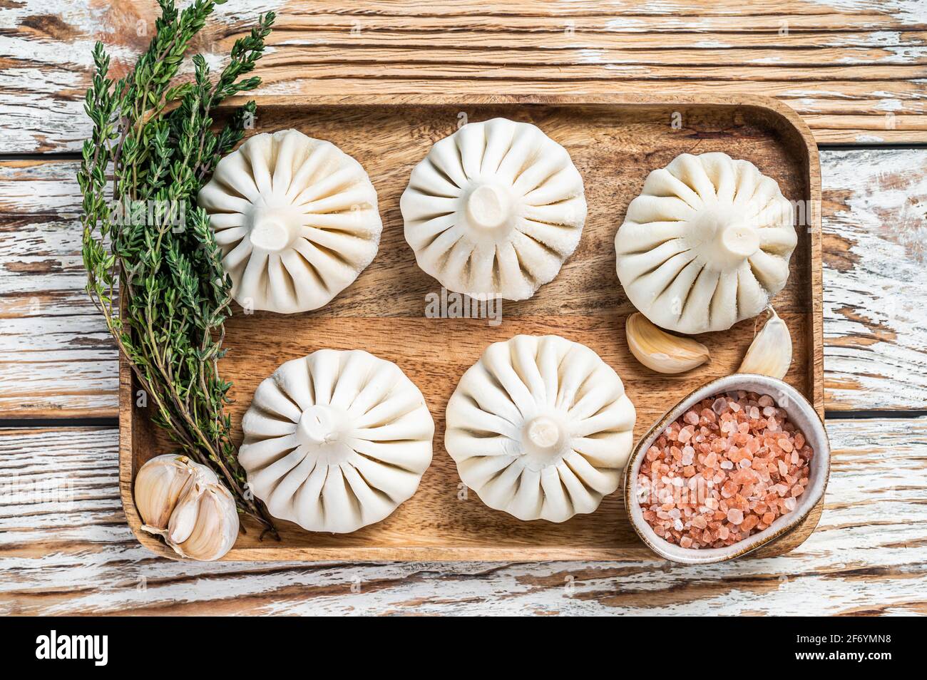 Frozen Raw dumplings Khinkali with beef and lamb meat on wooden tray ...
