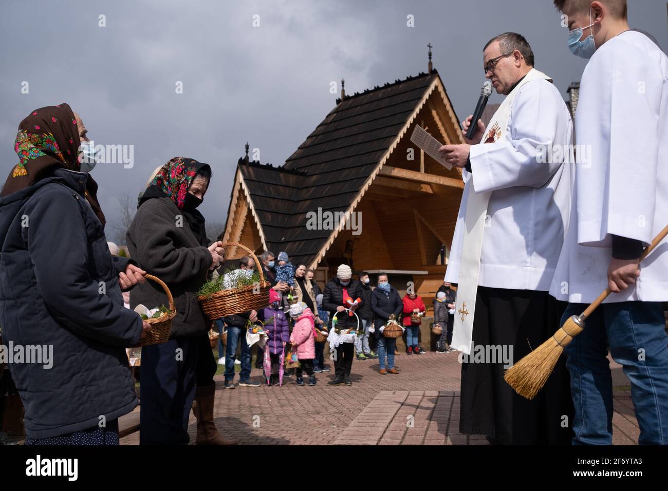 A priest seen blessing the food on the Holy Saturday.Traditional ...