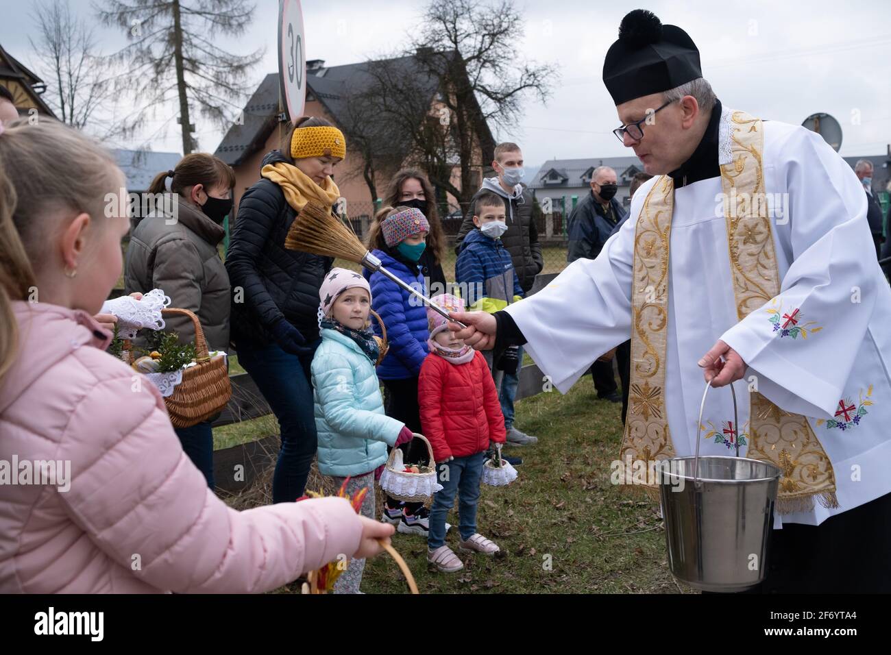 A priest seen blessing the food on the Holy Saturday.Traditional ...