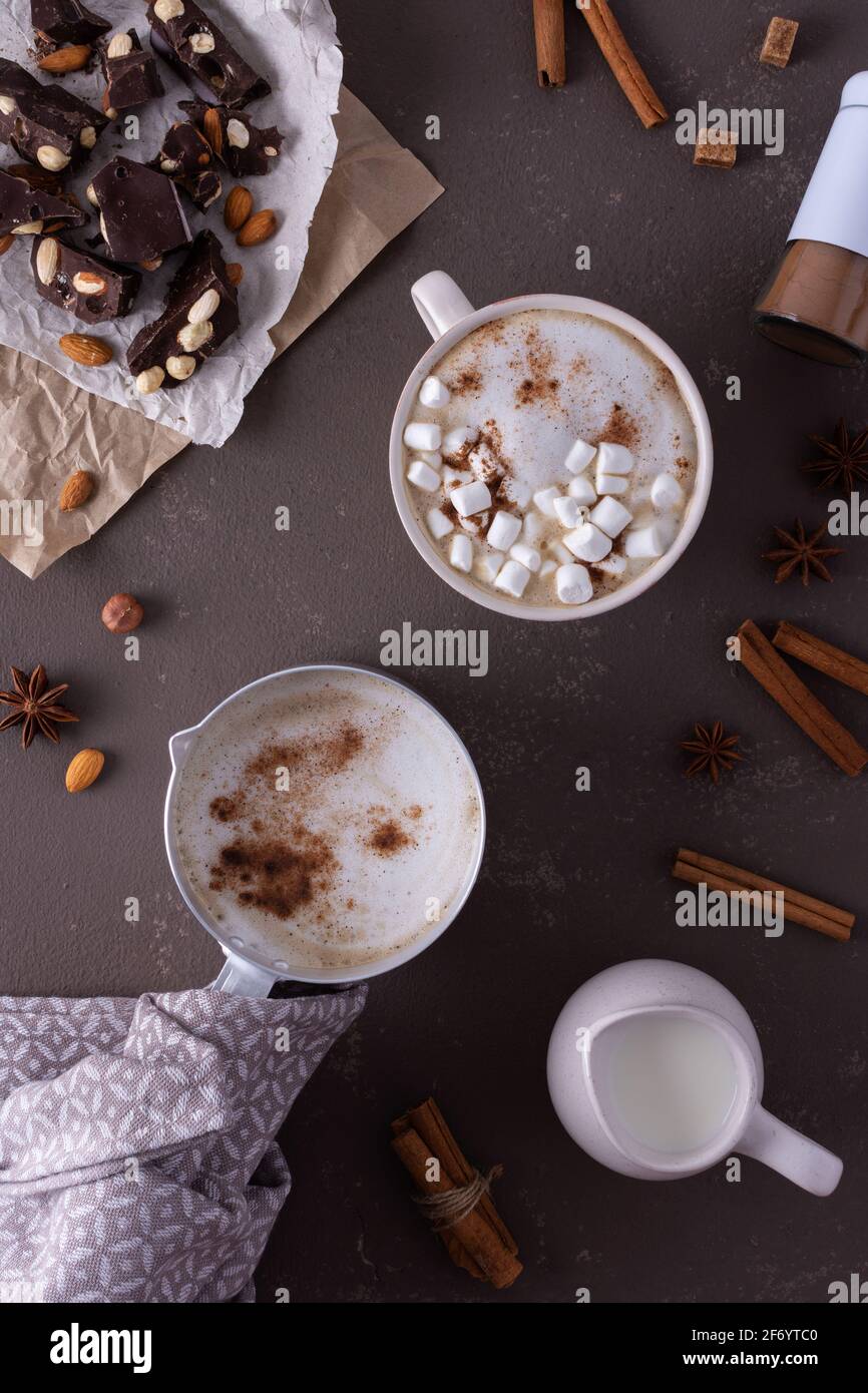 Winter cocoa drink with milk foam in a mug and an aluminum scoop ...