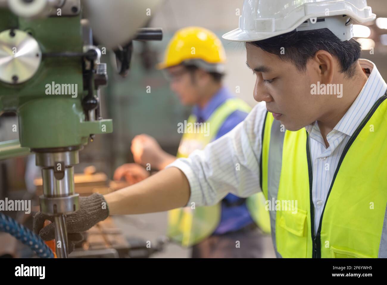 Two workers in production plant as team discussing, industrial scene in ...