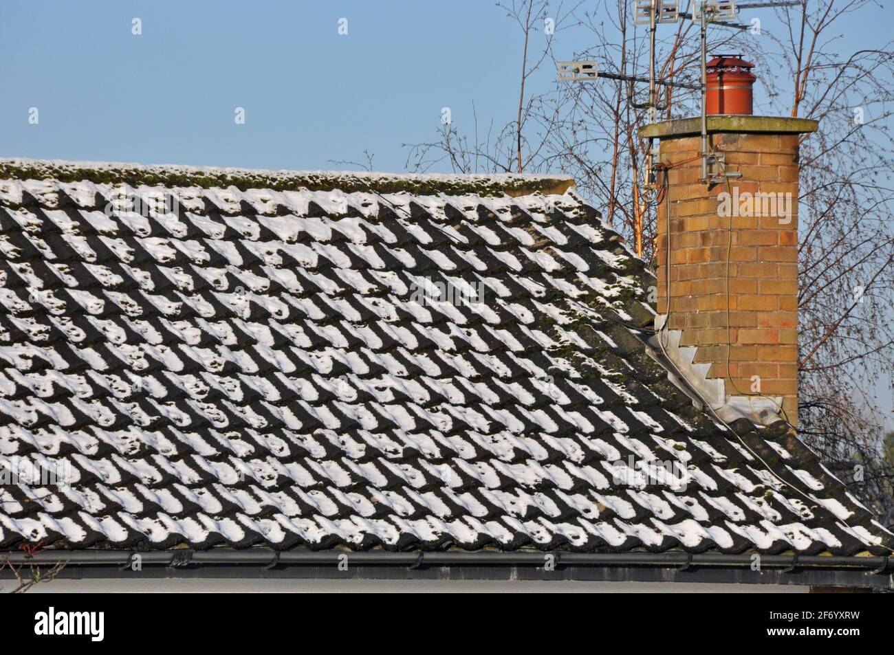 Snow on urban tiled roof Stock Photo - Alamy