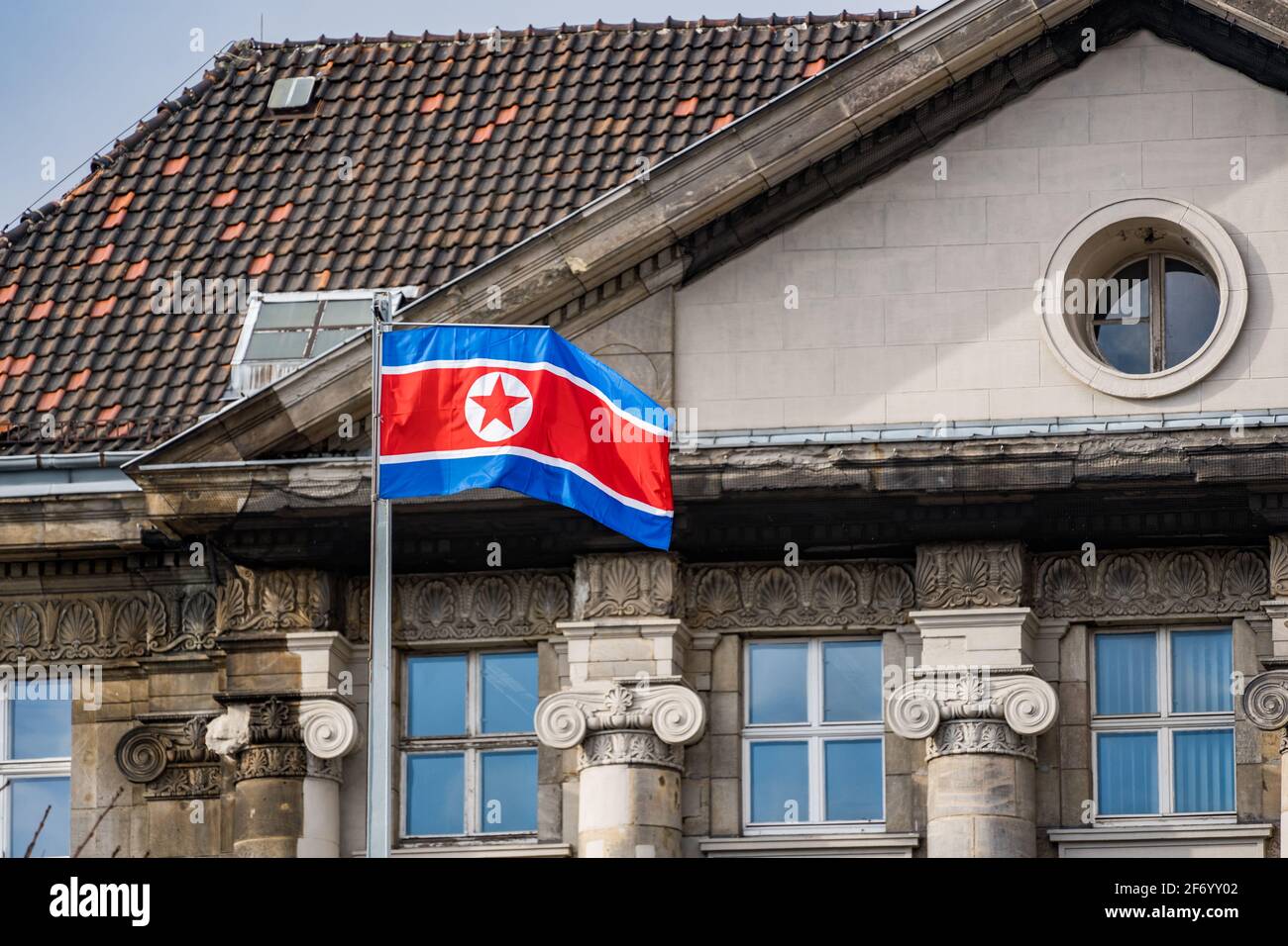 north korean flag waving in front of old building in berlin Stock Photo ...