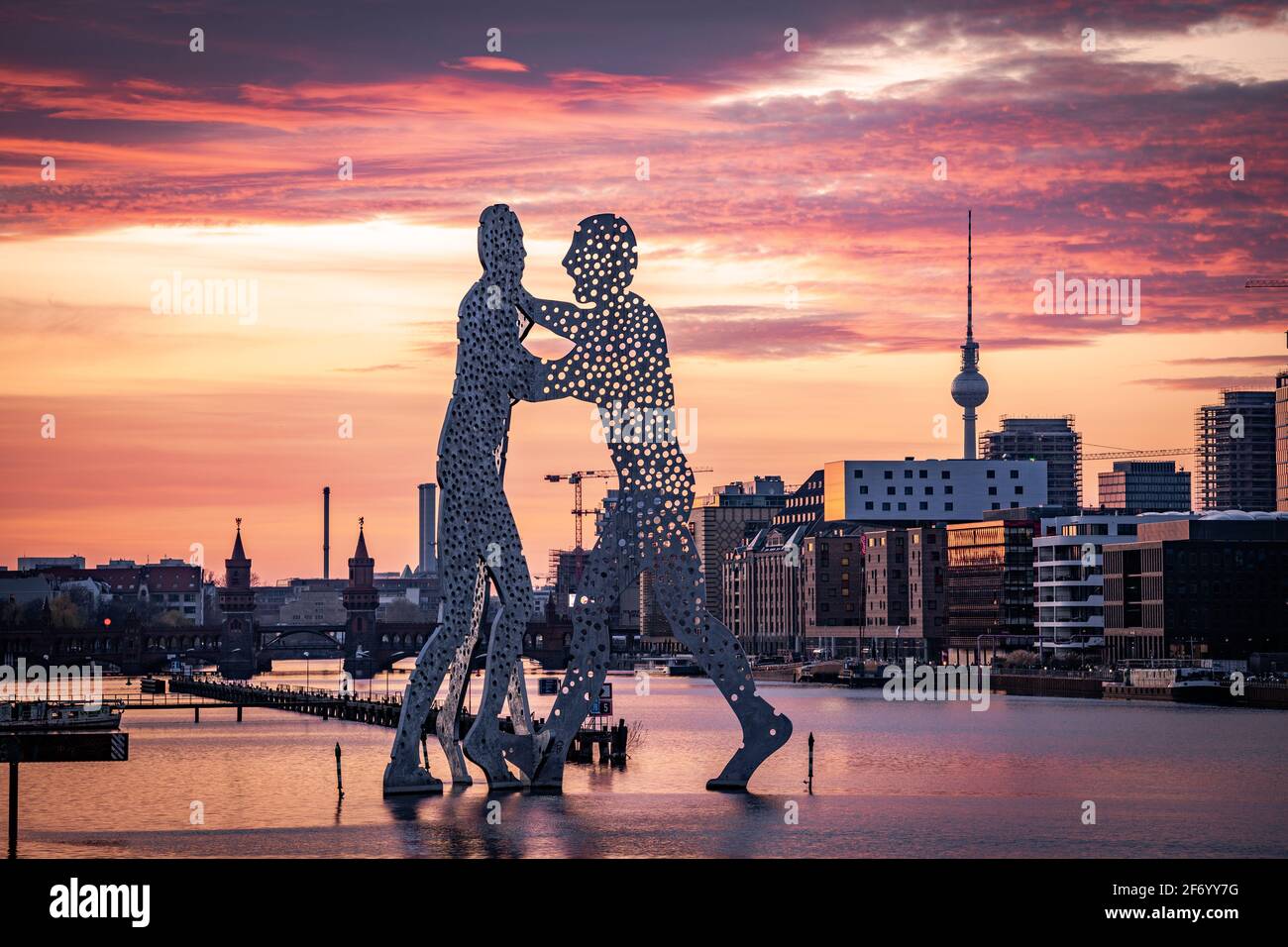 statue of Molecule Man in the river spree with view on berlin during ...