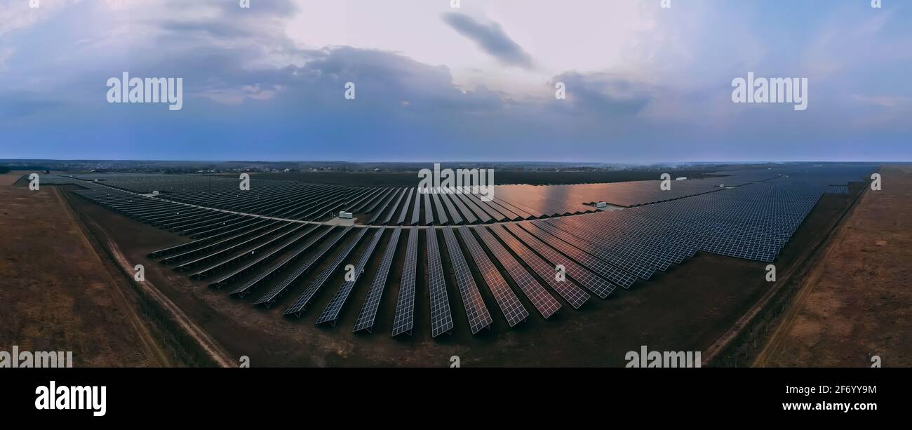 Aerial panorama view of large solar panels at a solar farm at bright ...