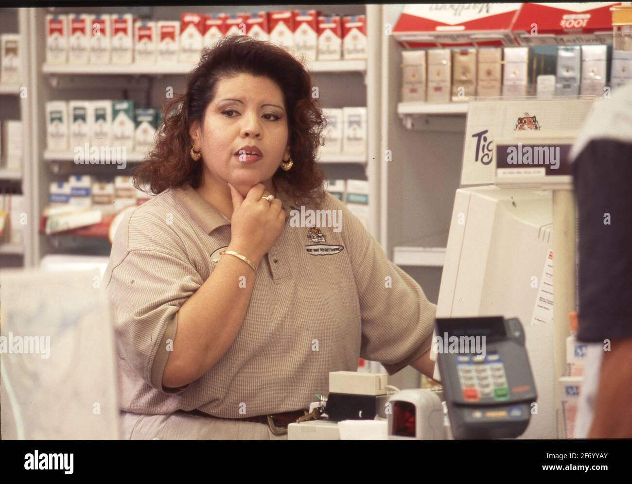 Hispanic female convenience store worker Melissa Sosa at an Exxon-Mobil ...