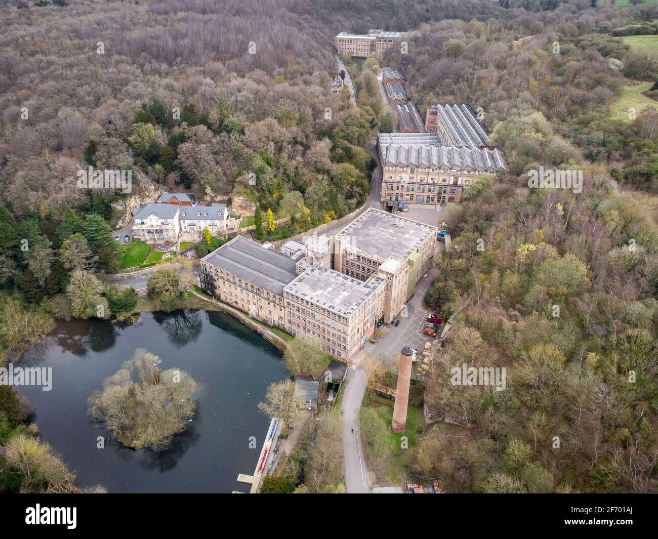 Sunrise sky over old English industrial cotton mill building valley ...