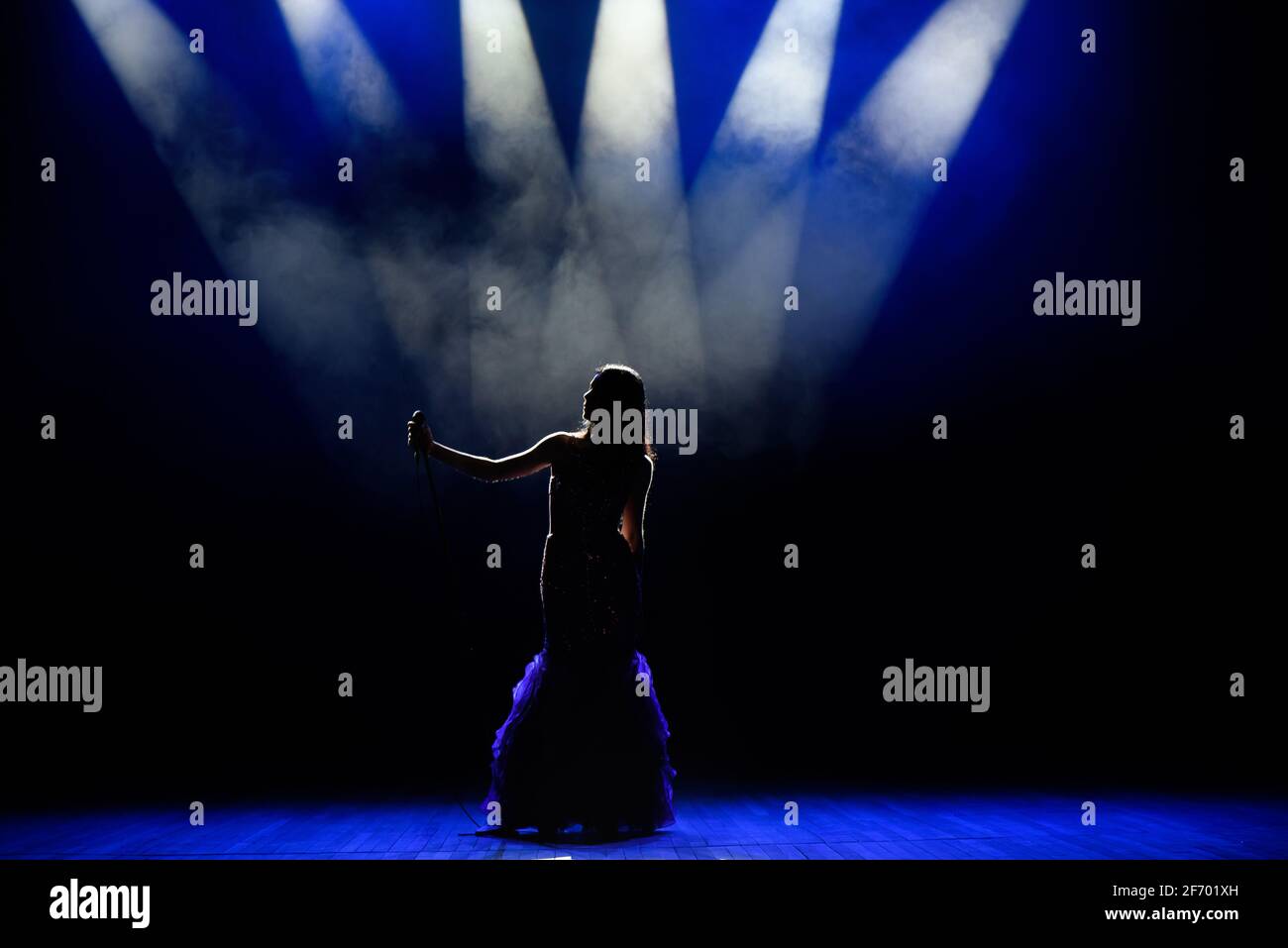 A young woman singer on stage during a concert Stock Photo - Alamy