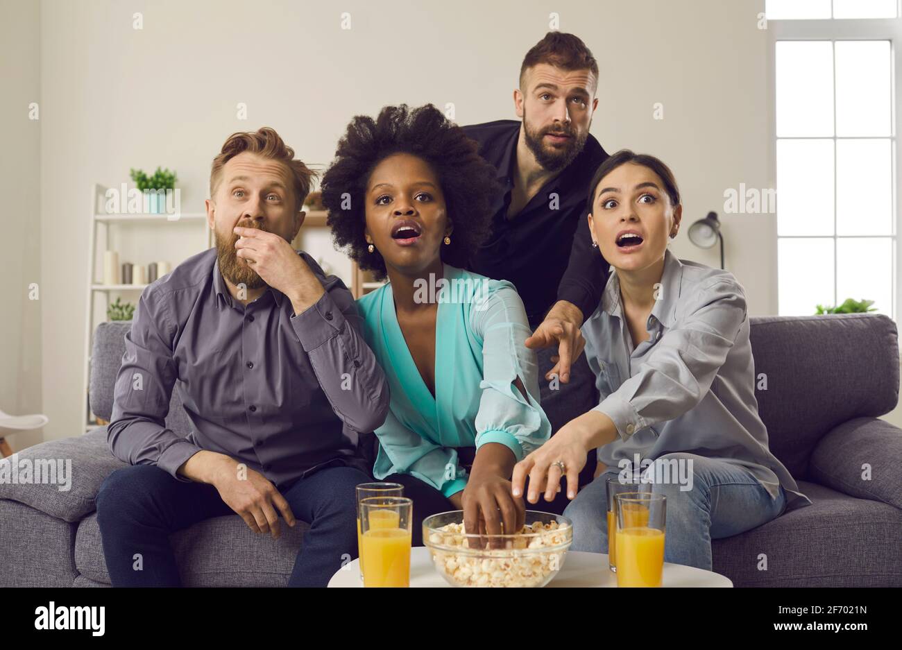 Group of international friends enjoy time together watching an ...