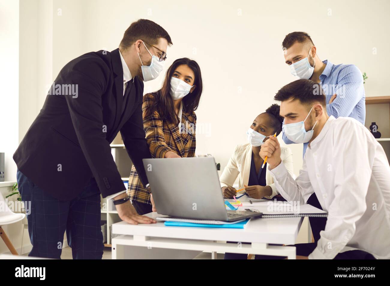 Creative business team meeting after lockdown in new normal safe office ...