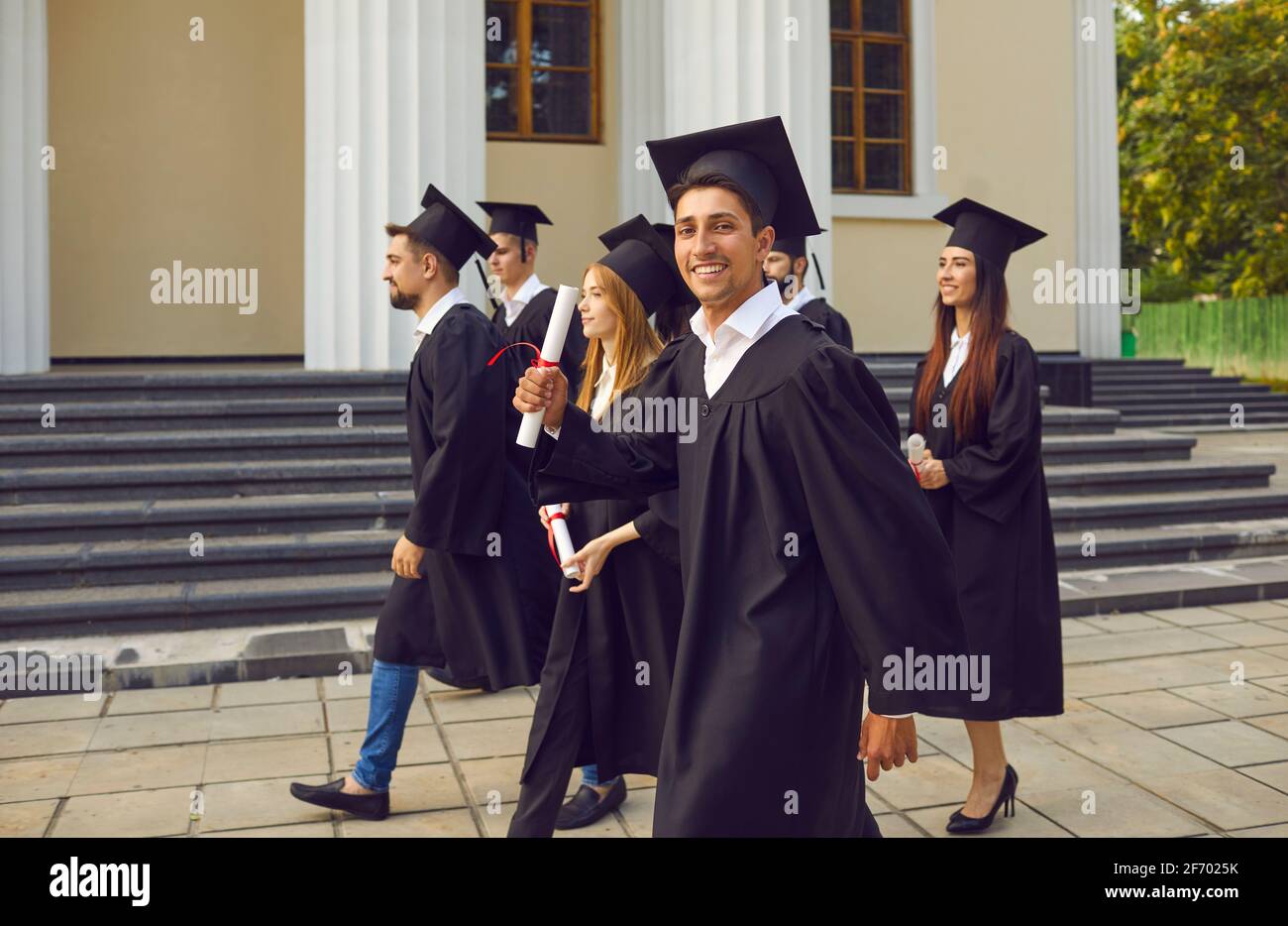 happy student boy confidently walks next to his classmates after the ...