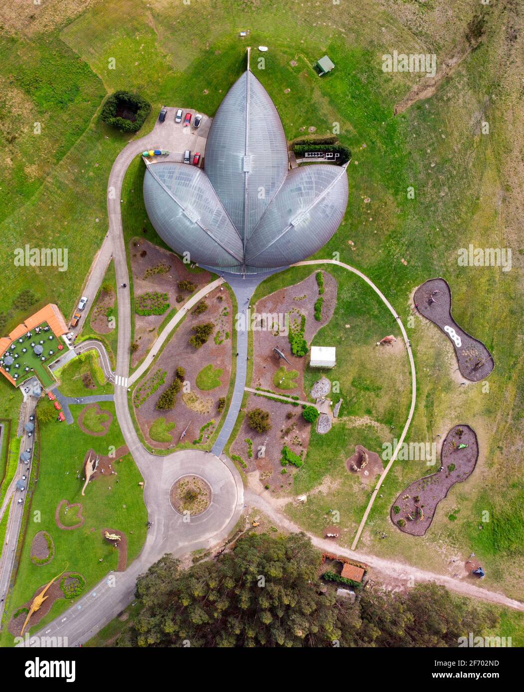 Aerial view of the Jurassic Museum in the shape of a dinosaur footprint ...