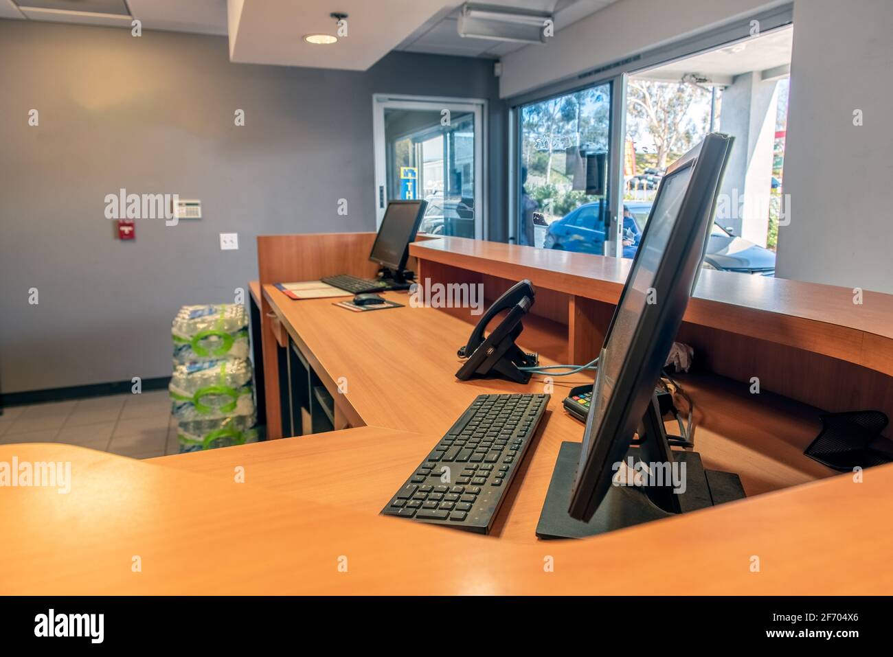 Customer service counter with computer, keyboard, and phone sit ready ...