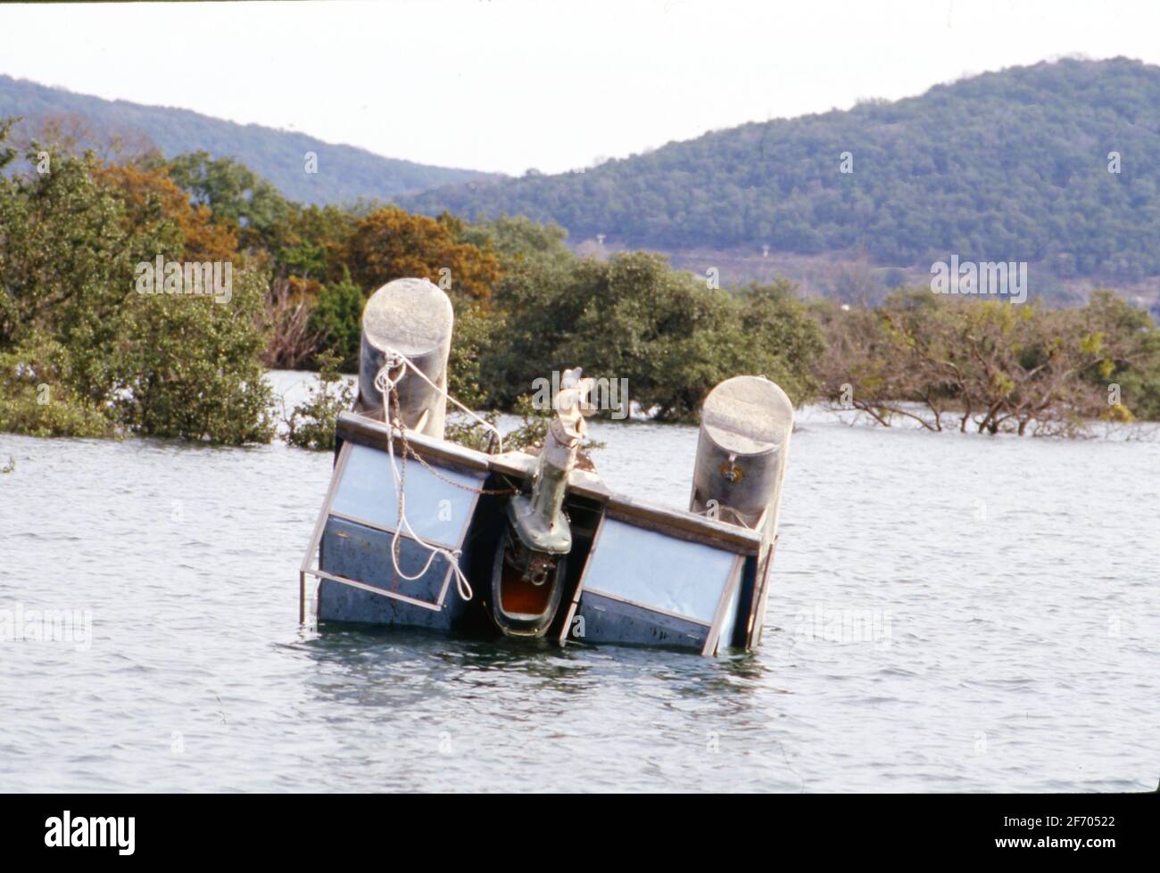 Overturned pontoon boat floats in the flooded Graveyard Point ...