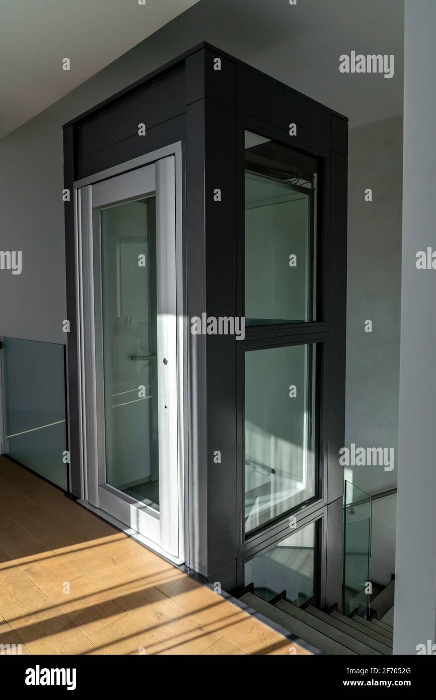 Apartment interior with modern glass elevator. Architecture design in ...