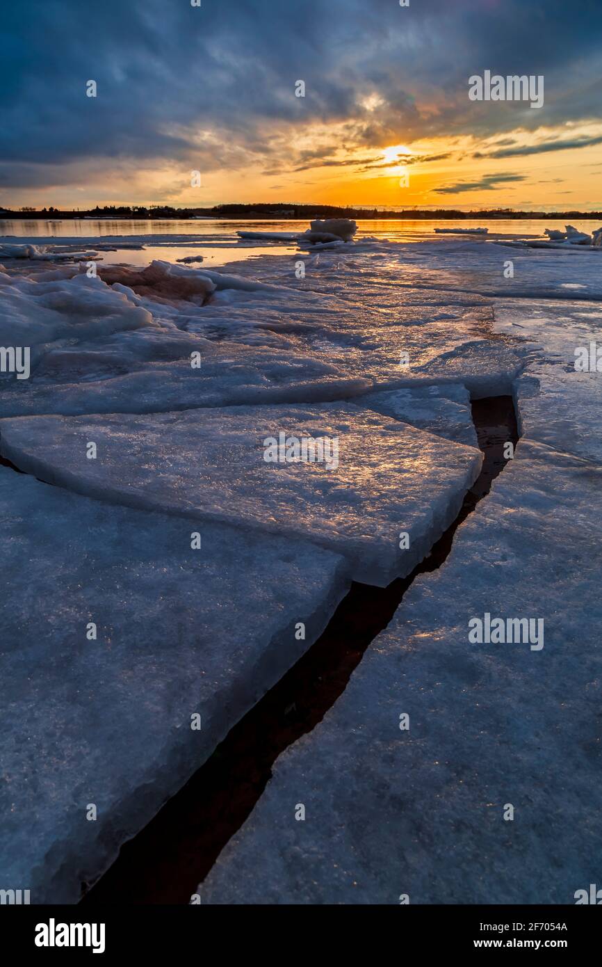 Winter landscape with frozen ice sheets floating on a lake during a ...