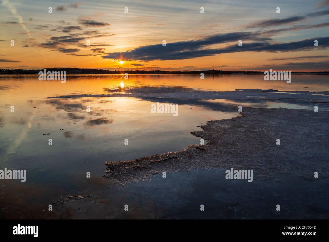 Winter landscape with frozen ice sheets floating on a lake during a ...
