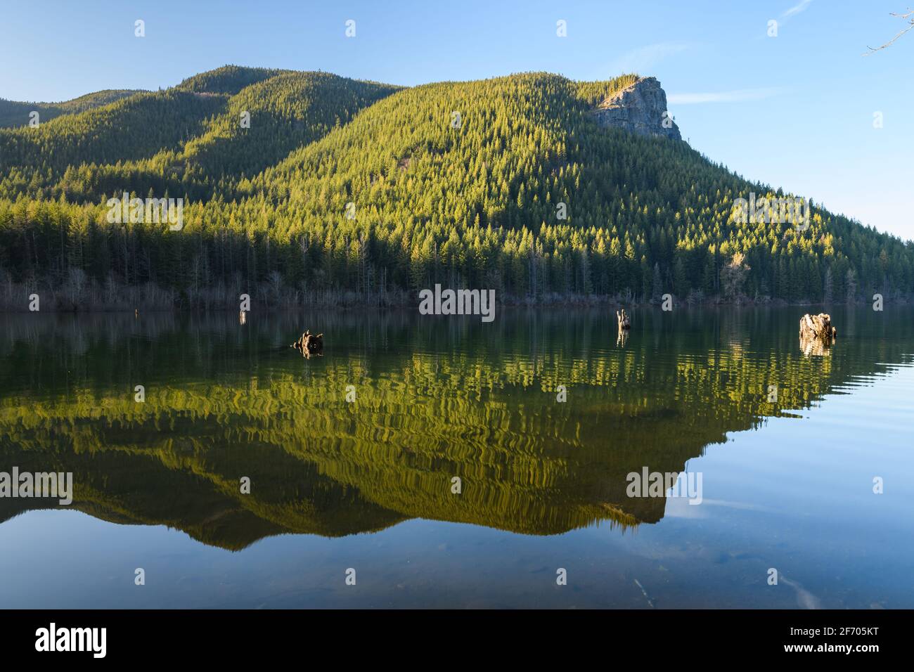 Rattlesnake Ledge reflects in Rattlesnake Lake below showing the ...