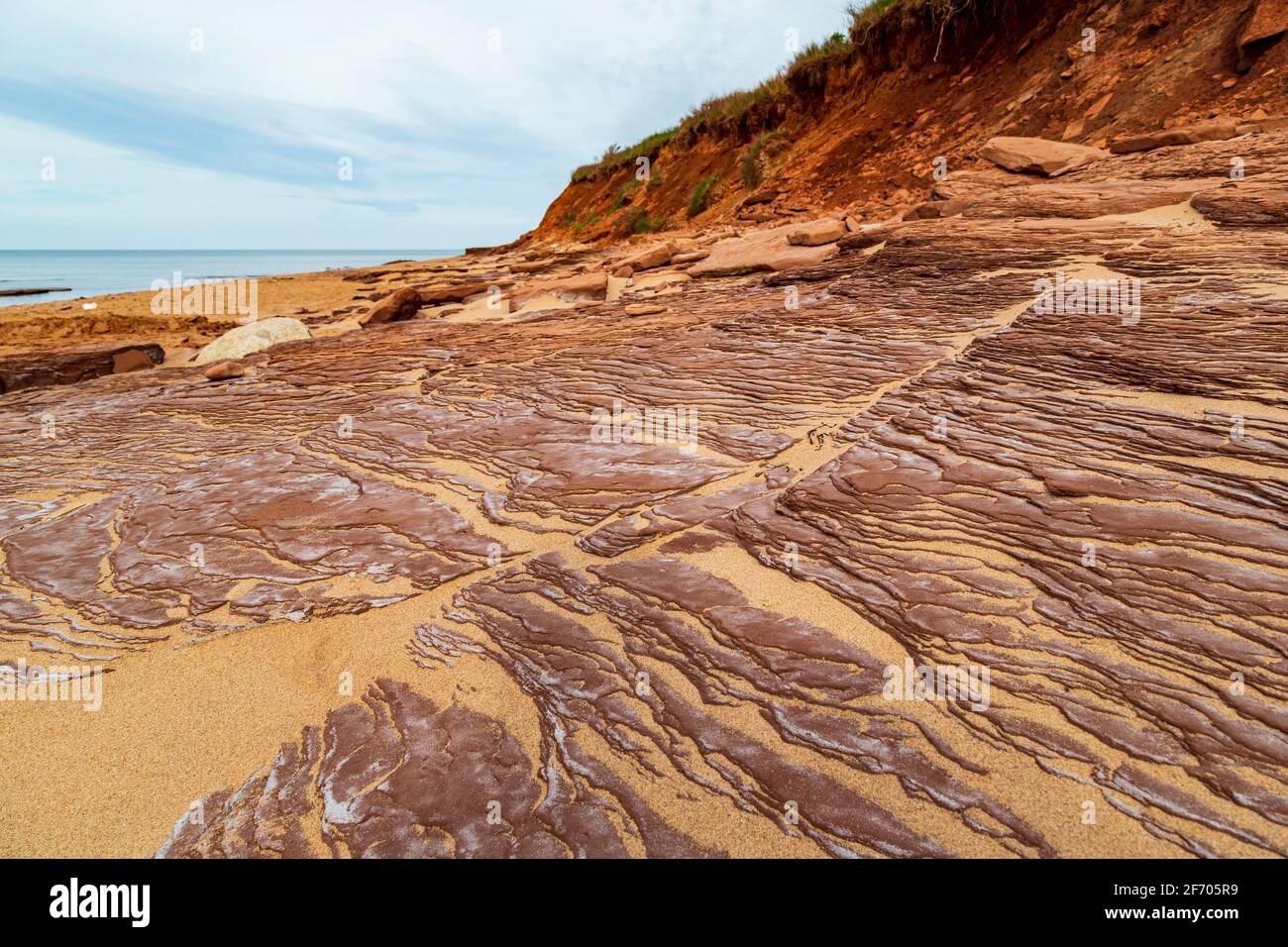 A red sandstone beach on Canada's Prince Edward Island is weathered ...