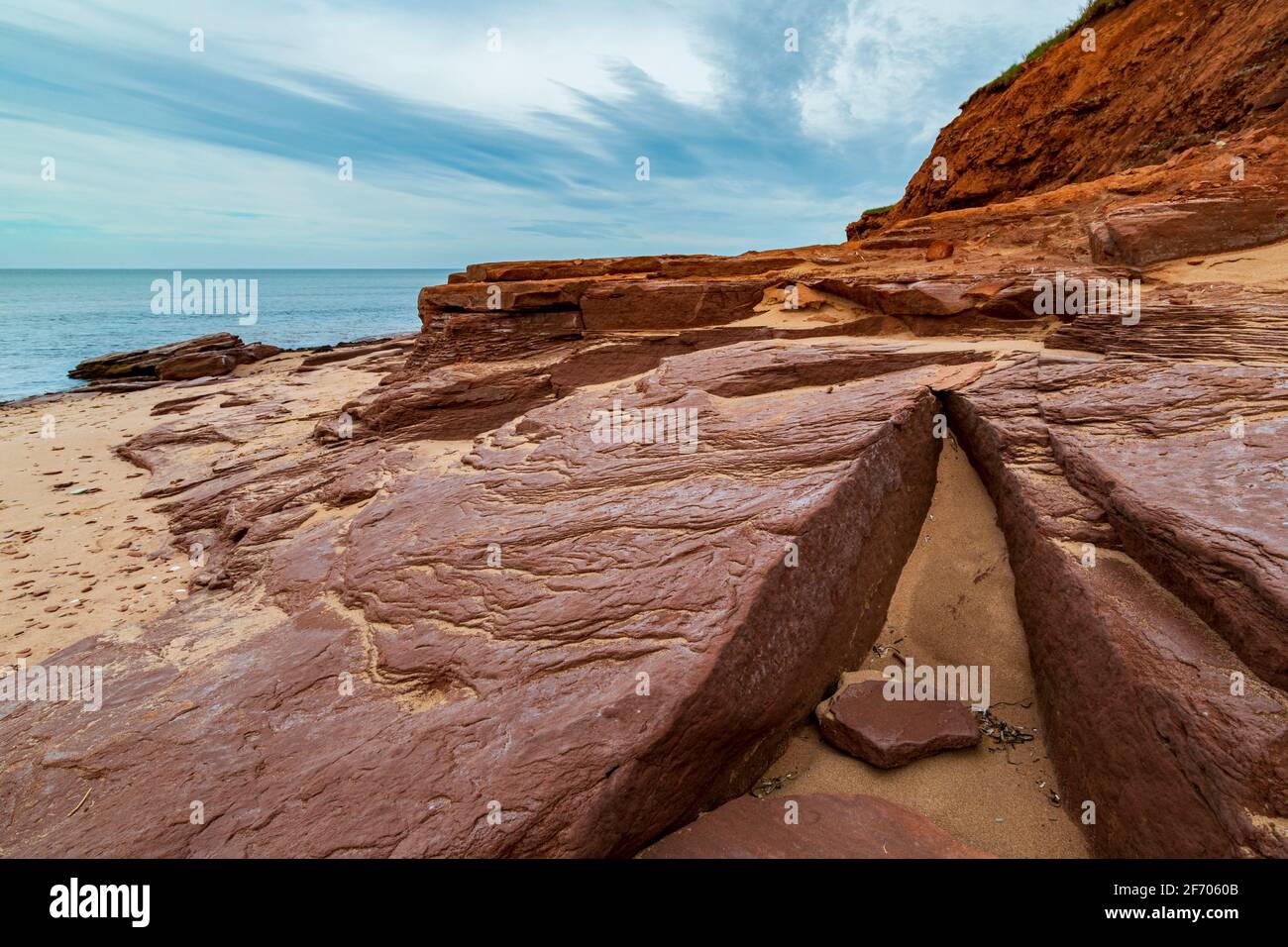 Red sandstone cliff and rocks at Cavendish beach of Prince Edward ...