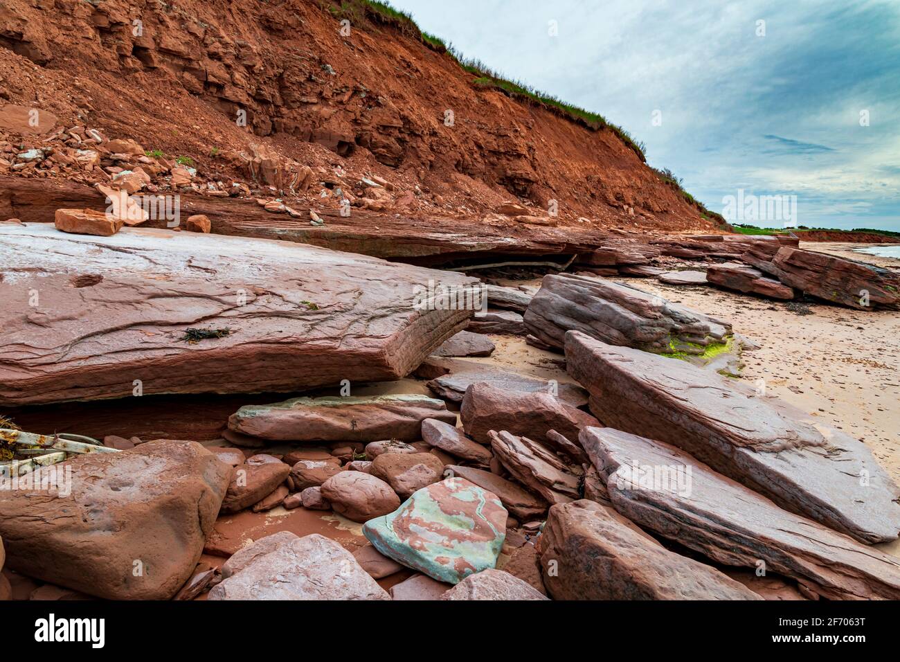 Red sandstone cliff and rocks at Cavendish beach of Prince Edward ...