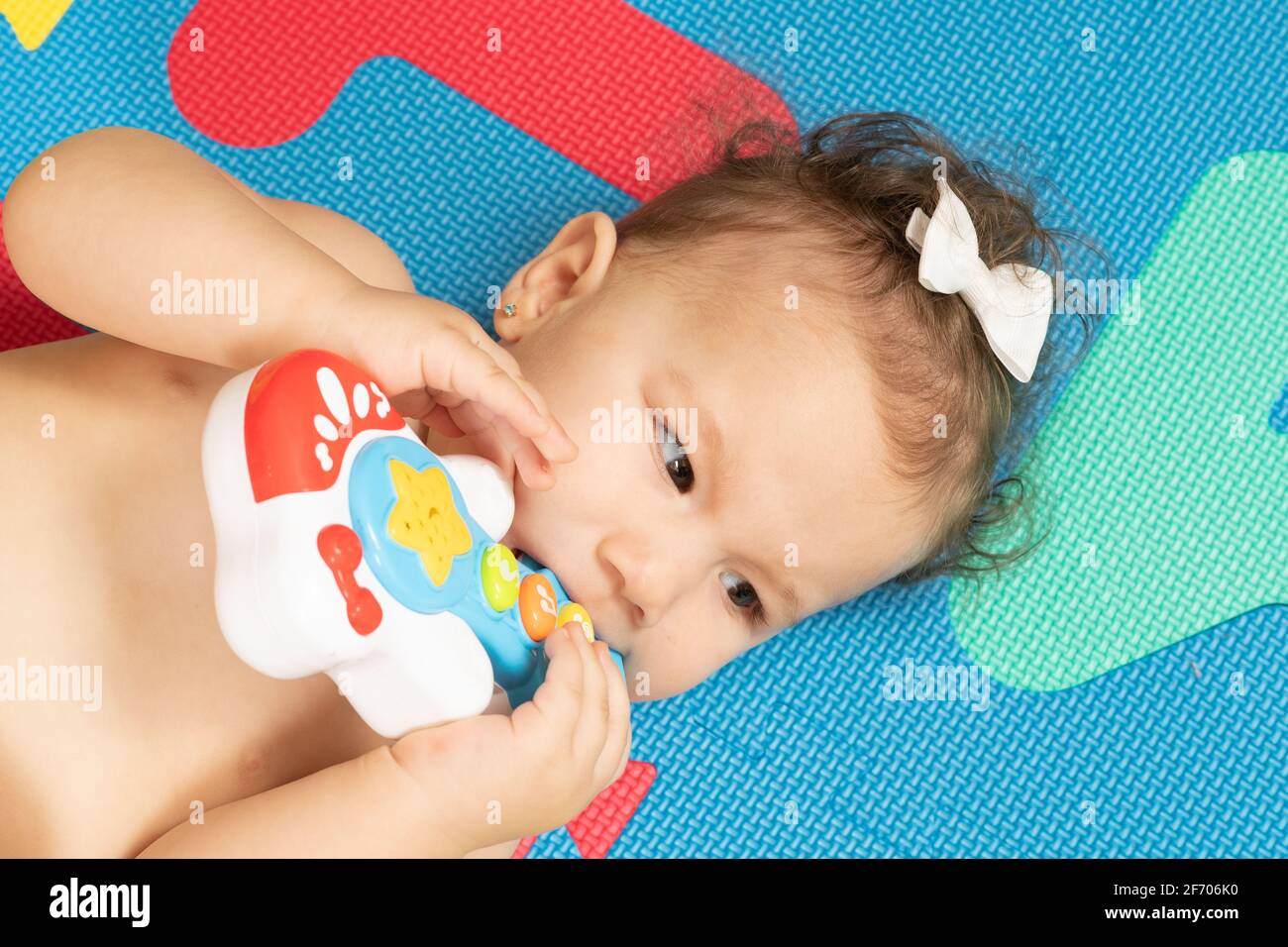 Child mouthing plastic toy hi-res stock photography and images - Alamy