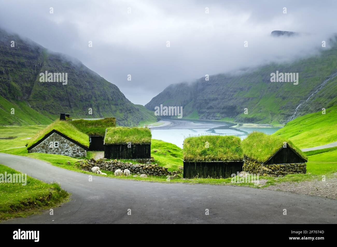 Beauty landscape with grassy houses and high mountains near famous ...
