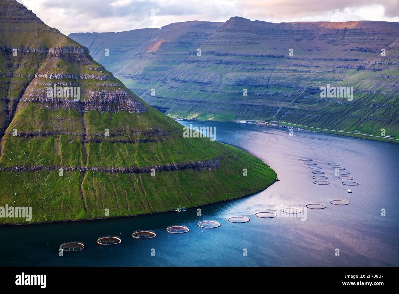 Dramatic morning view on fish farm on Kalsoy island near Klaksvik city ...