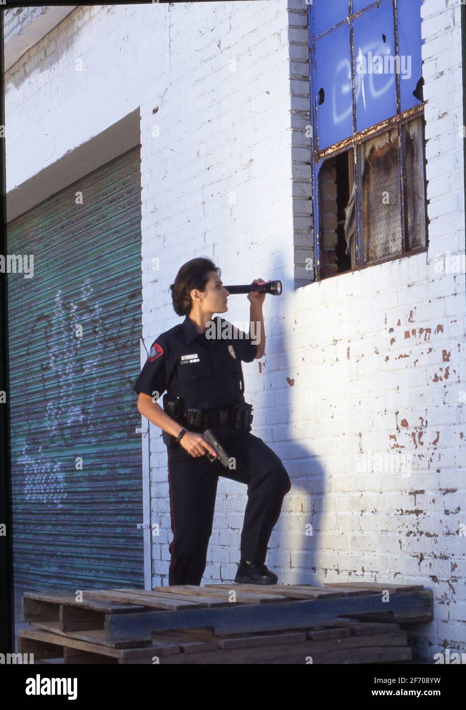 Austin, Texas USA, 1997: Female police officer investigates broken ...