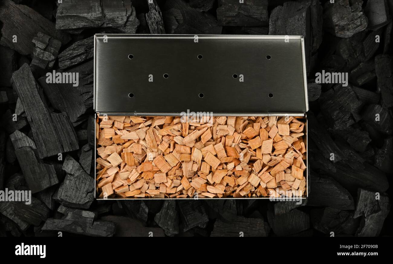 Close up one stainless steel metal smoker box with hardwood alder chips ...