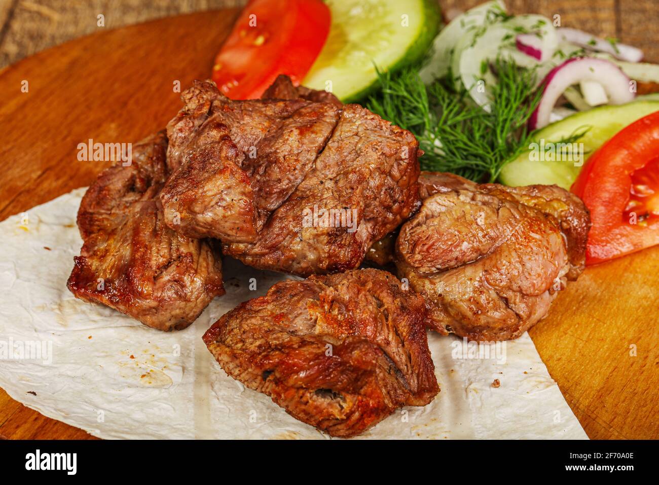 Grilled beef barbeque served vegetables and onion Stock Photo - Alamy