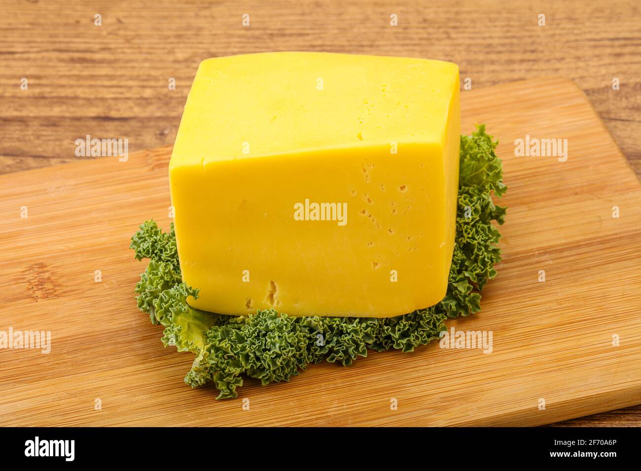 Yellow tilsiter cheese dairy product brick Stock Photo - Alamy