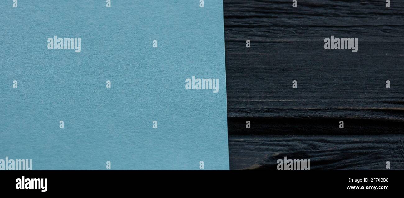 Colored paper background and wood black texture. blue paper can be used ...