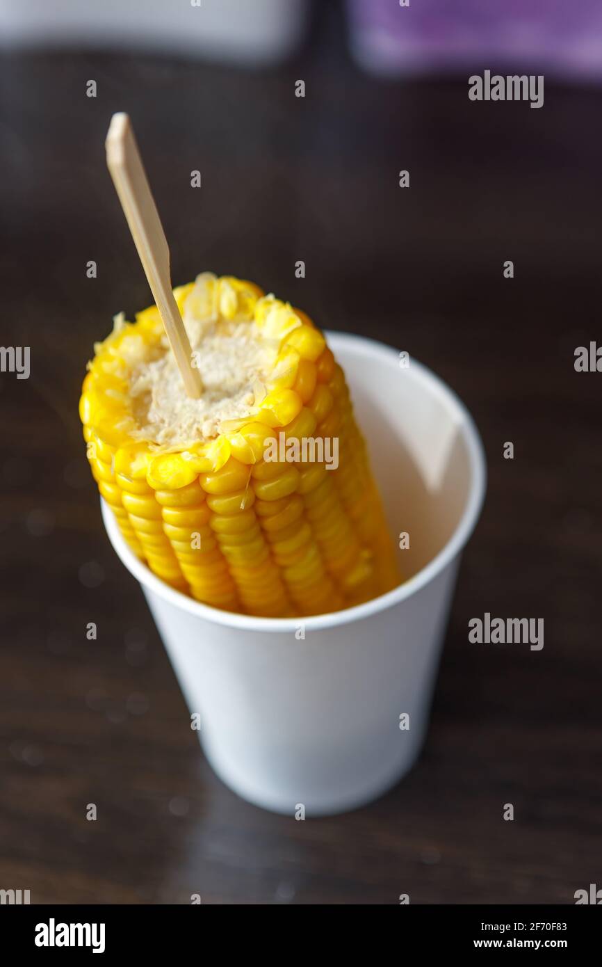 An ear of boiled corn in a paper cup. Fast food concept Stock Photo - Alamy